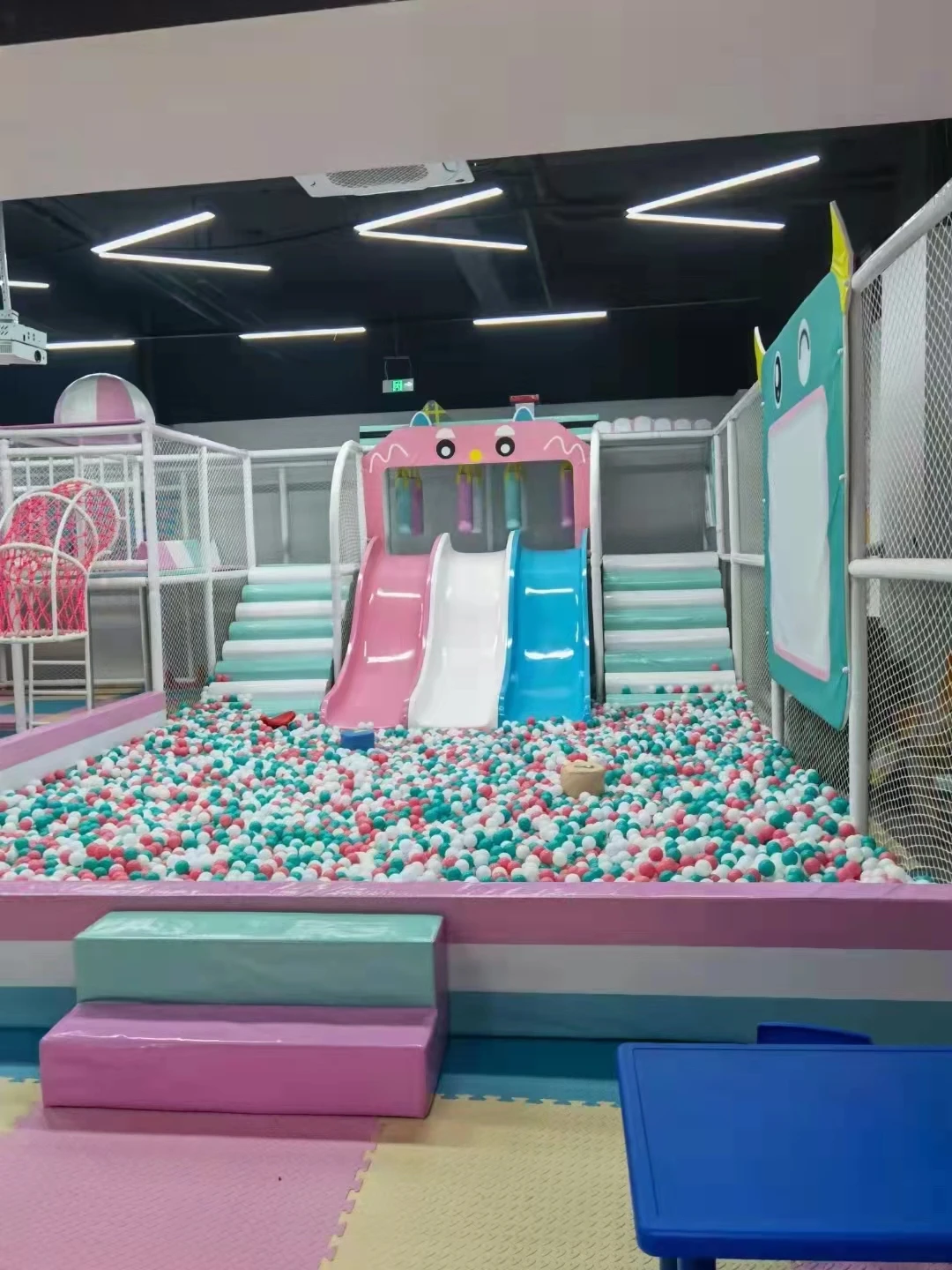 Indoor Playground with Light Blue and Pink Color Scheme